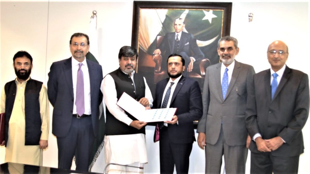 SECP Chairman Akif Saeed unveiled a commemorative postage stamp to mark ...